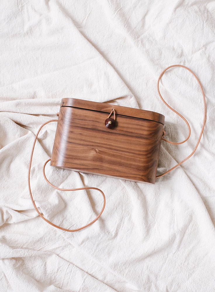 The Bag is made with American Walnut wood.